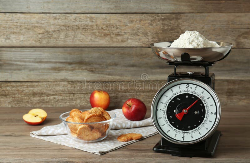 Kitchen Scale with Flour, Cookies and Apples on Wooden Table Stock ...