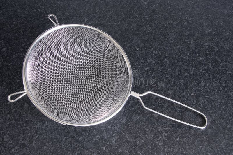 Kitchen Sieve on a Dark Counter Top Stock Image - Image of household ...