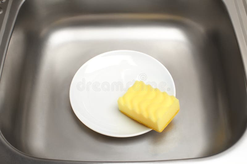 Kitchen Sink with Clean White Plate and Yellow Cleaning Sponge Stock ...
