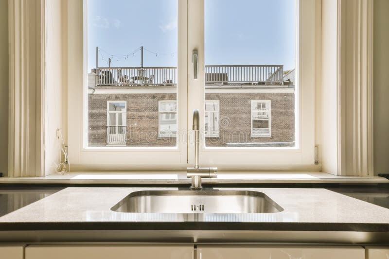 A Kitchen Sink in Front of a Window Stock Image - Image of cabinet ...