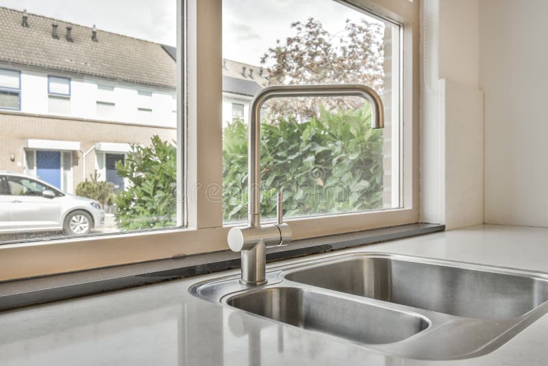 A Kitchen with a Sink and a Washing Machine Stock Photo - Image of ...