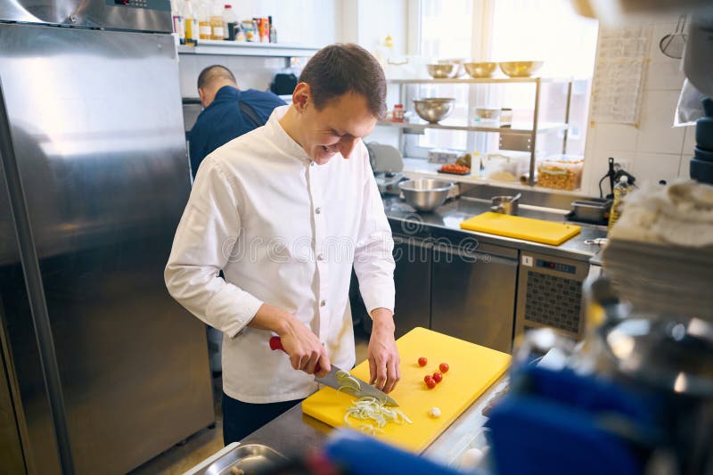 Kitchen Staff Cuts Vegetables on a Yellow Cutting Board Stock Image ...