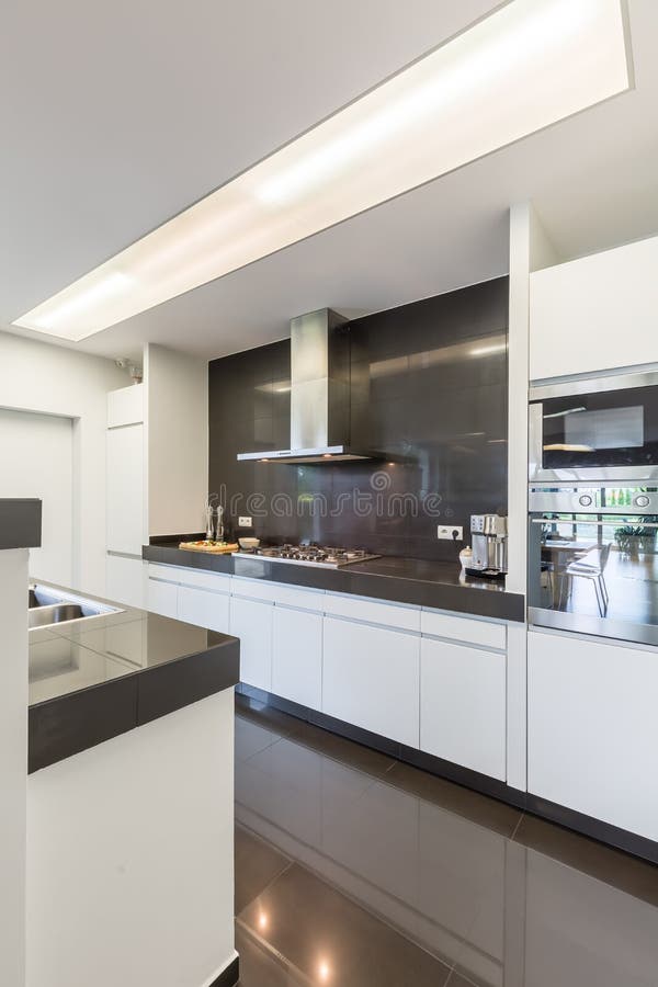 Kitchen with steely canopy stock image. Image of interior - 80562507