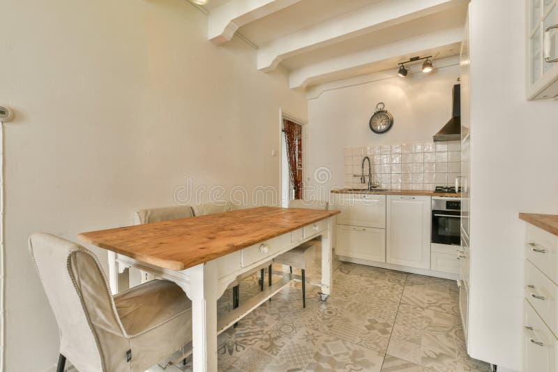A Kitchen with a Table and Chairs and a Sink Stock Photo - Image of ...