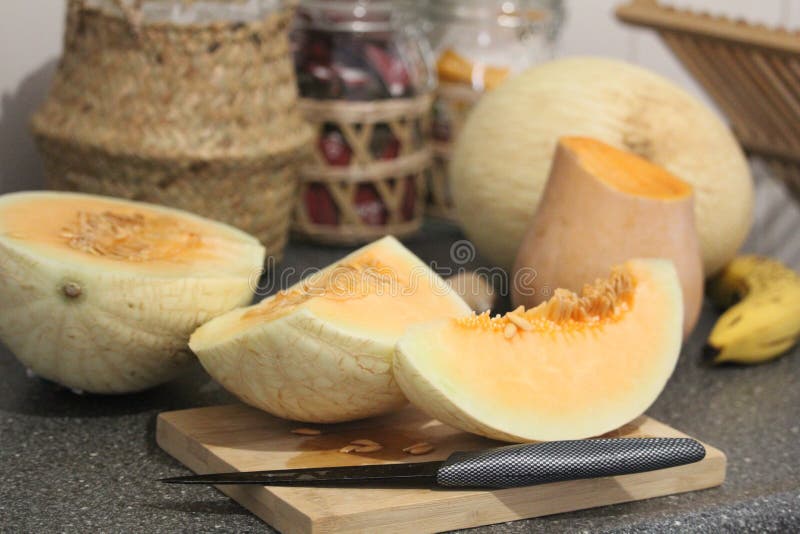 Kitchen Table with Cut and Whole Melons Stock Photo - Image of blurry ...