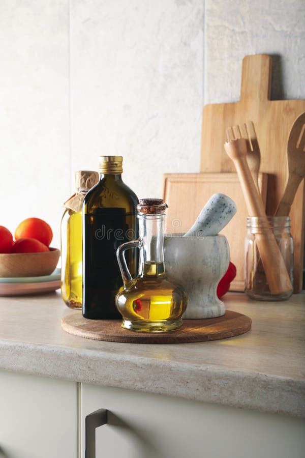 Kitchen Table with Different Supplies and Bottles with Oil Stock Photo ...