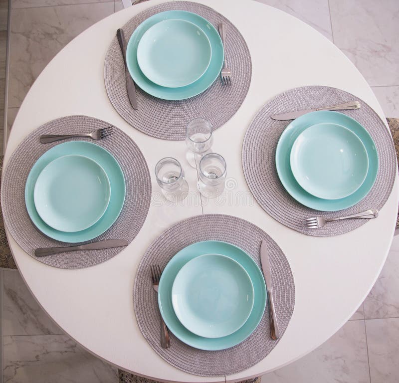 Kitchen Table Setting with Turquoise Plates and Glasses. Cutlery on ...