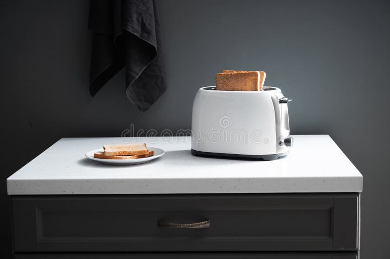 Toaster with Bread Slices on Kitchen Table Stock Photo - Image of food ...