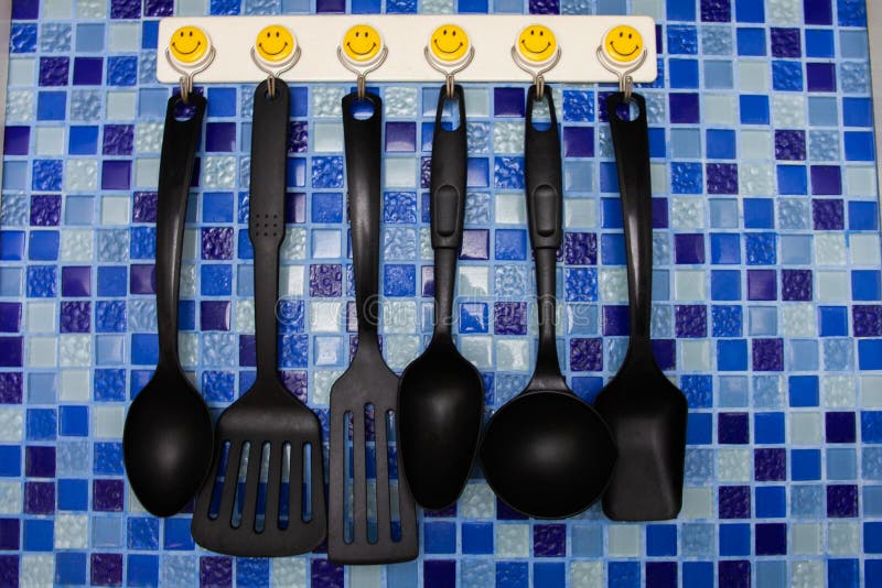 Kitchen with Tools, Pans, Pots Hanging on Brick White Wall and Glass ...
