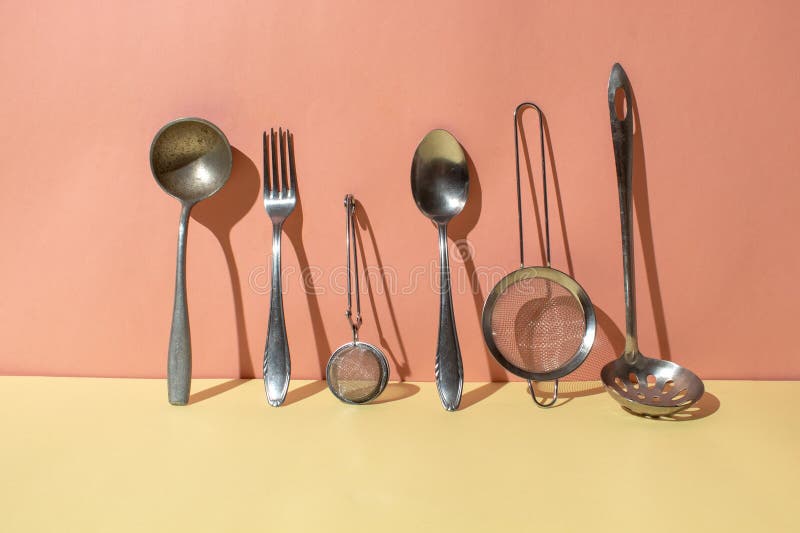 Kitchen Utensils Arranged in a Horizontal Row Next To the Pink Wall ...