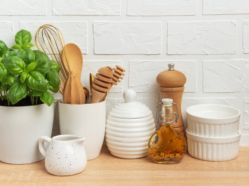 Kitchen Utensils, Basil Plant and Condiments Resting on Wooden ...