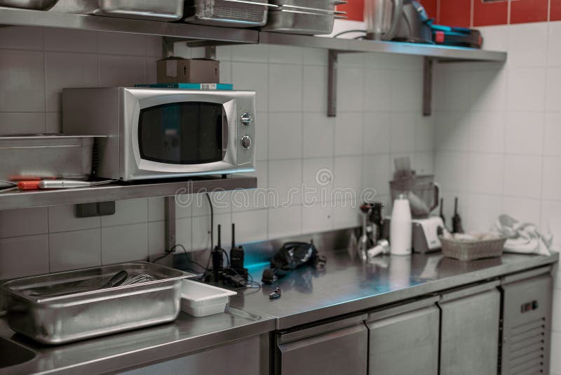 Kitchen Utensils, Pans and Pots in a Professional Kitchen. Industrial ...