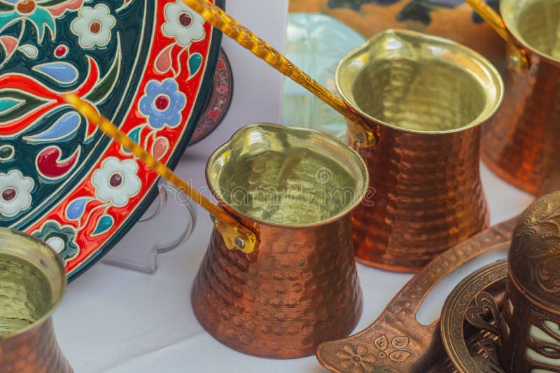 Kitchen Utensils on Table with White Tablecloth: Several Bronze ...