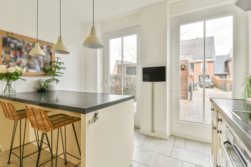 A Kitchen with White Cabinets and a Black Counter Top Editorial Image ...