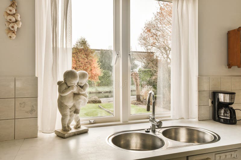 A Kitchen with a Window and a Statue of Two Stock Photo - Image of home ...