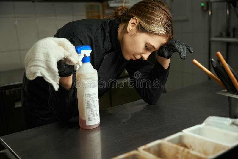 Kitchen Worker is Leaning Over Table and Holding Her Head Stock Image ...