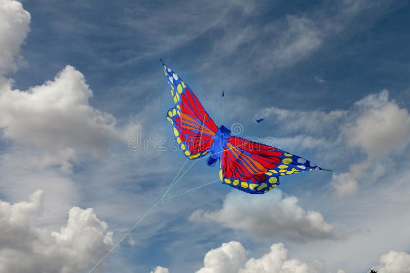 A Kite in the Shape of a Butterfly Flying Stock Image - Image of midair ...