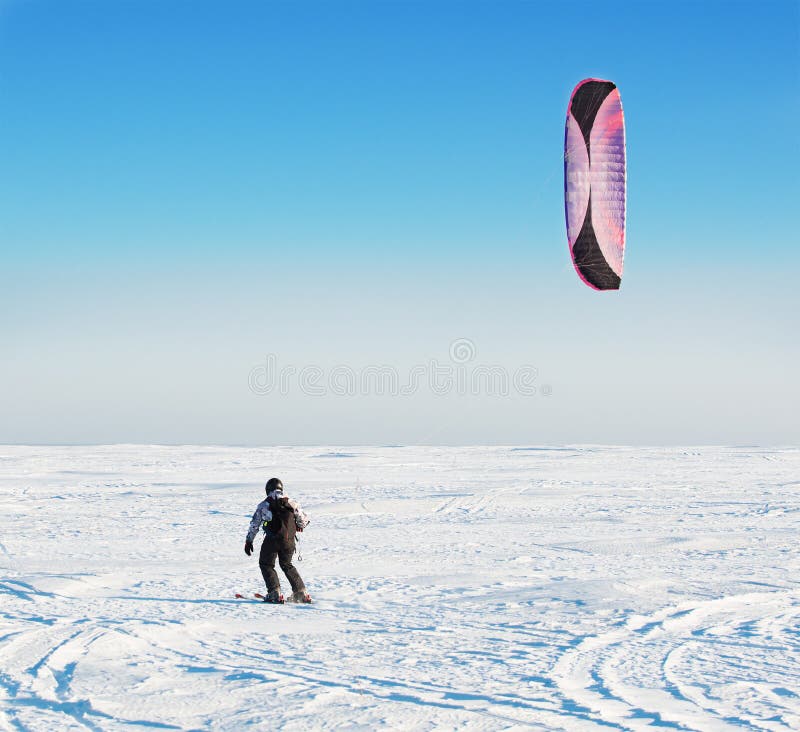 Kite Surfer Being Pulled by His Kite Across the Snow Stock Photo ...