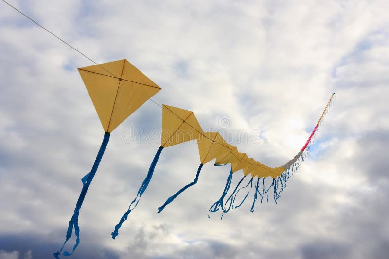 Kite Train of Yellow Kites with Blue Ribbons Stock Photo - Image of ...