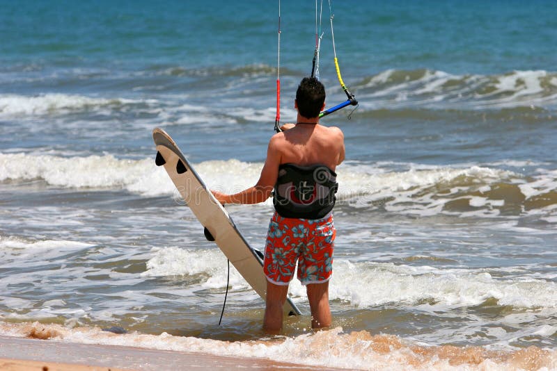 A Male Kiter Slides On The Surface Of The Water. Splashes Of Water Fly ...