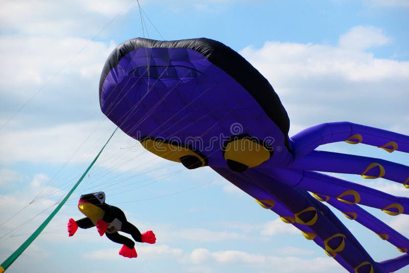 Kites in a bright blue sky stock image. Image of kiting - 76148743