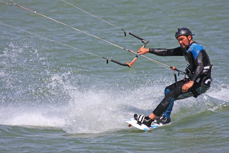 Kitesurfer riding at speed editorial image. Image of surf - 150742185