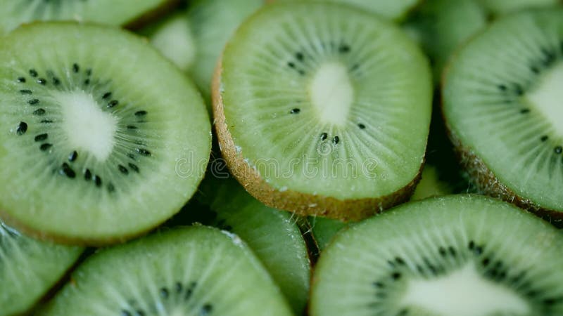 4K Kiwi Fruit. Heap Sliced and Whole Kiwi Fruit Close Up, Rotating ...