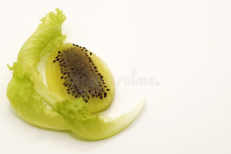 Kiwi in the Shape of an Easter Egg Cut in Half Next To a Lettuce Leaf ...