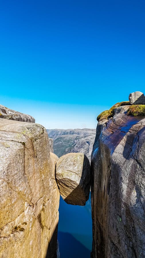 Kjeragbolten, Norway a Large Boulder Precariously Perched between Two ...