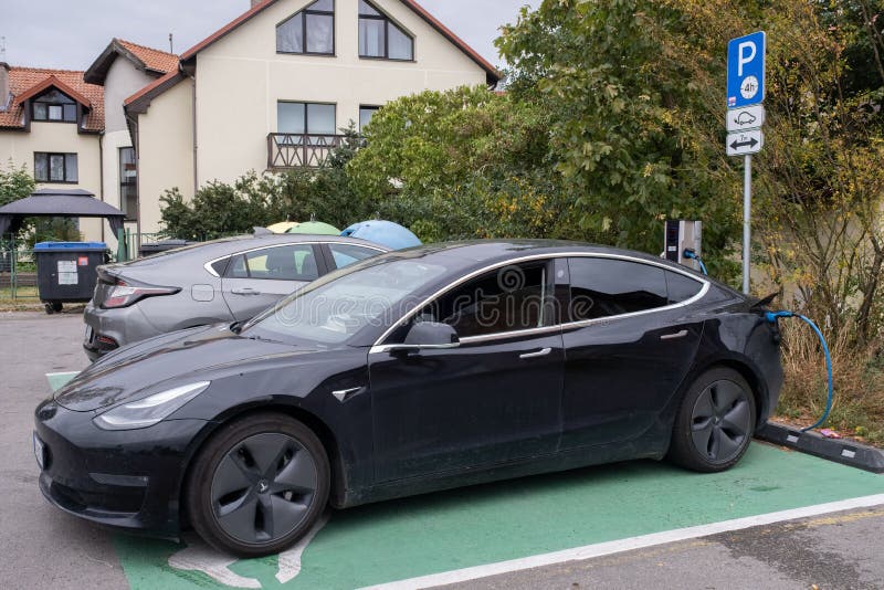 A Static Shot of a Solid Black Tesla Model 3 Dual Motor Charging at the ...