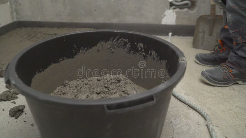 Bucket with a Solution. Knead the Solution with a Mixer in a Bucket of ...