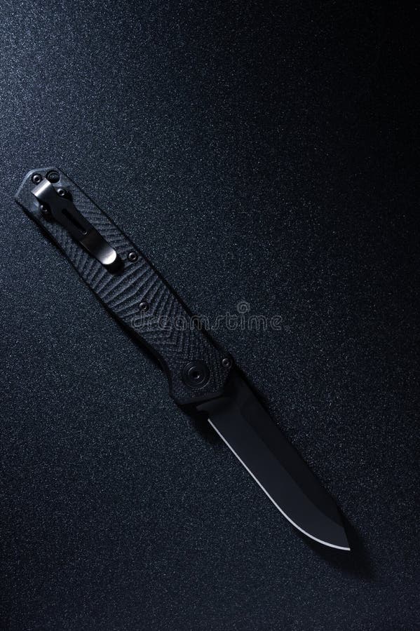 Knife with Black Blade and Handle. a Knife with a Shiny Edge. Vertical ...