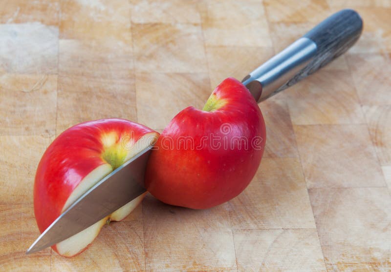 Knife Cutting an Apple on Chopping Board Stock Photo - Image of metal ...