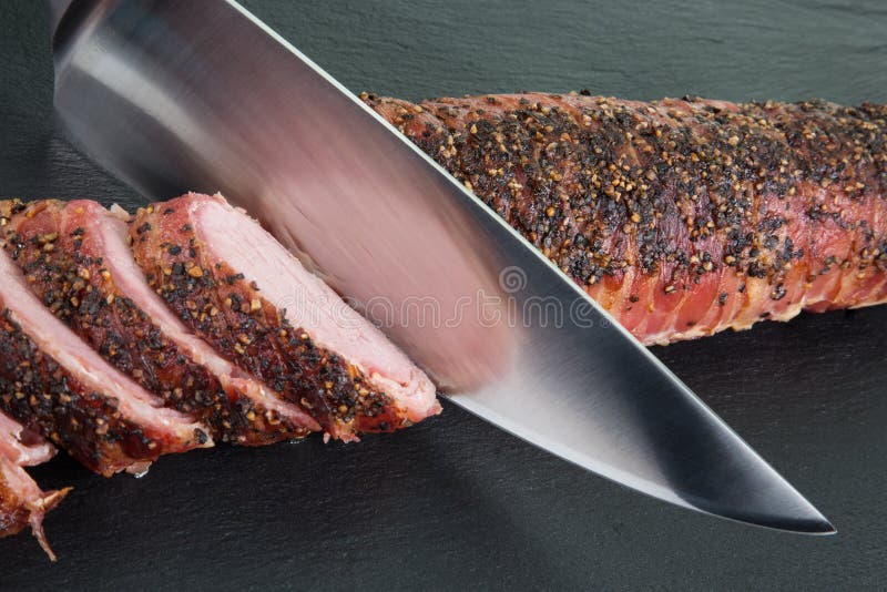 Knife is Cutting a Big Portion of Roast Pork on a Dark Backround Stock ...