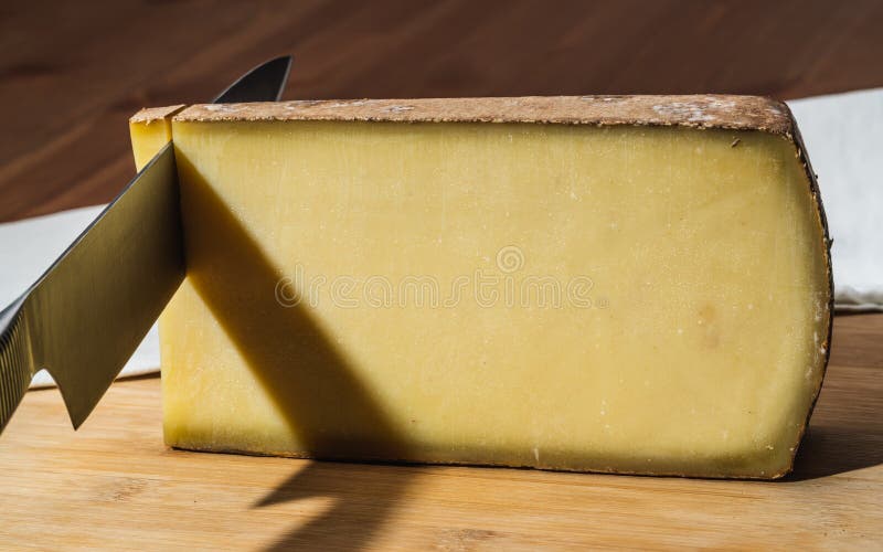 Knife Cutting a Piece of Comte a Famous French Cheese Stock Image ...