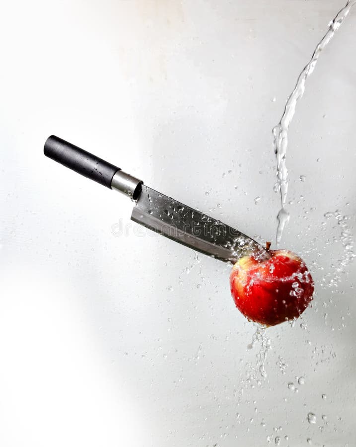 Knife Embedded in the Apple Stock Photo - Image of closeup, motion ...