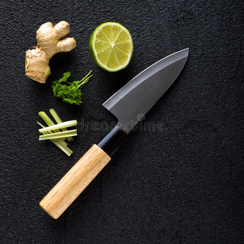 Knife and Food Ingredients on Black Stone Table Stock Photo - Image of ...