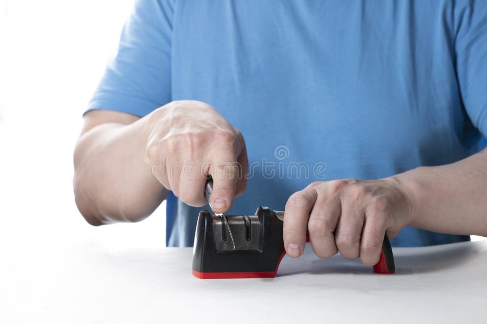 A Knife Sharpener. a Man Sharpens a Knife on a Special Universal Knife ...