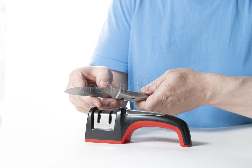 A Knife Sharpener. a Man Sharpens a Knife on a Special Universal Knife ...