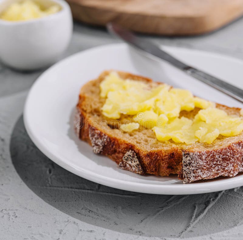 A Knife Spreading Melted Butter on Bread Stock Image - Image of snack ...