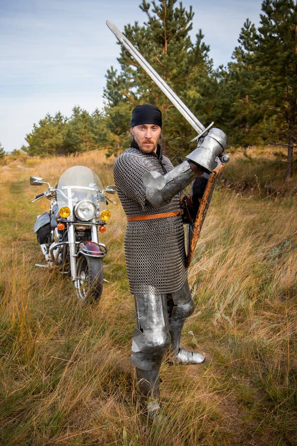 Knight in Chainmail with a Shield and a Sword in His Hands Stands ...
