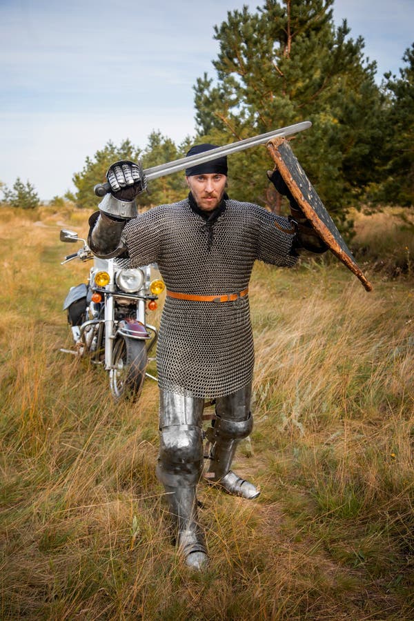 Knight in Chainmail with a Shield and a Sword in His Hands Stands ...