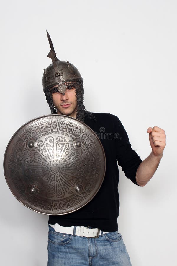 Young Guy is Posing in Studio with Helmet and Shield. Knight, Halloween ...