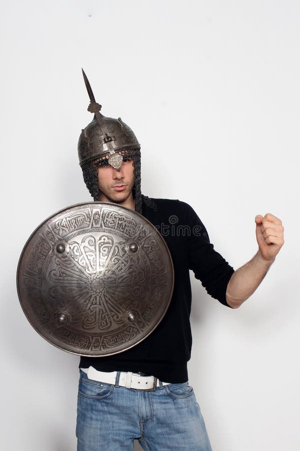 Young Guy is Posing in Studio with Helmet and Shield. Knight, Halloween ...