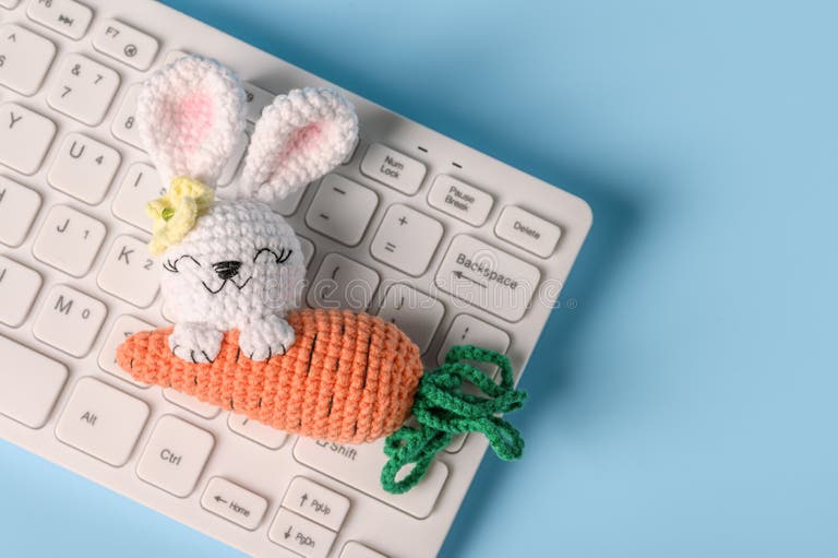 . Knitted Easter Bunny on a Blue Background with a Keyboard. Happy ...
