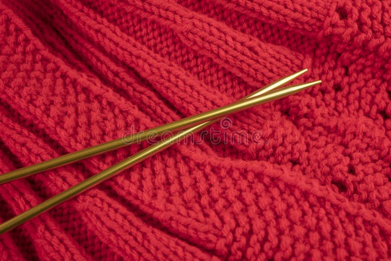 Knitted Garment in Red Yarn and Golden Knitting Needles Stock Image ...