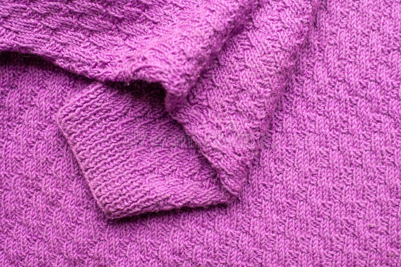 Knitted Purple Sleeve on a Knitted Purple Background. Stock Image ...