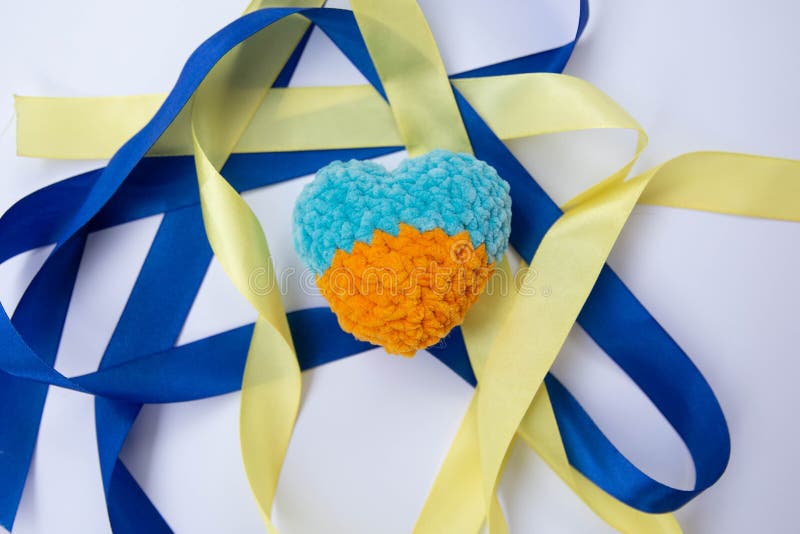 Knitted Yellow and Blue Heart with Multi-colored Ribbons on a White ...