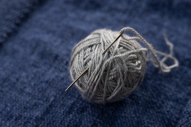 Knitting. Blue Wool Knitted Fabric and a Ball of Gray Thread with a ...