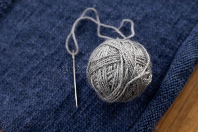 Knitting. Blue Wool Knitted Fabric and a Ball of Gray Thread with a ...